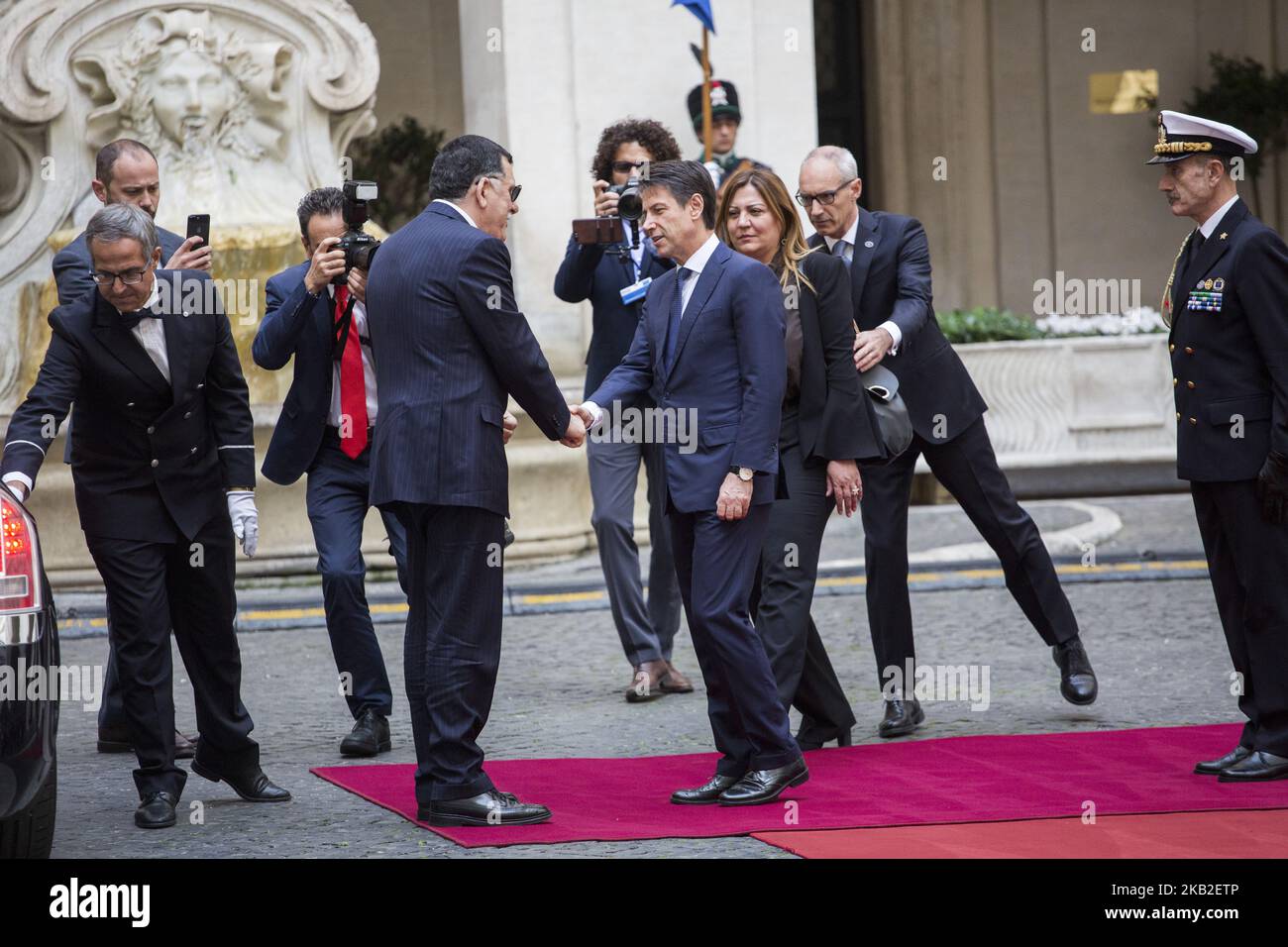 Italy's Prime Minister Giuseppe Conte (CR) welcomes the Chairman of the ...