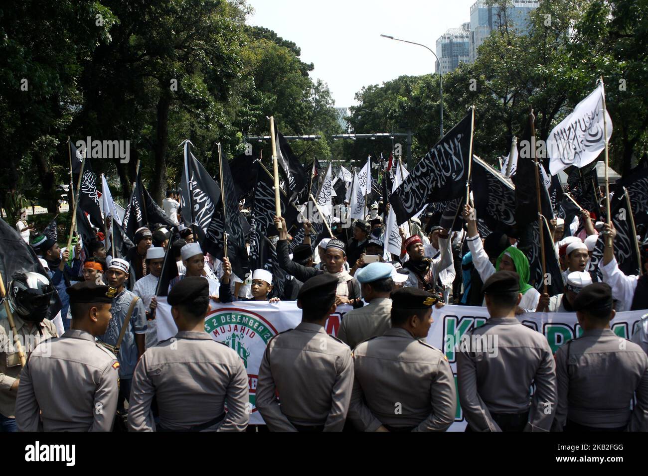 Indonesian Muslims carrying Tawheed flags and other attributes staged ...