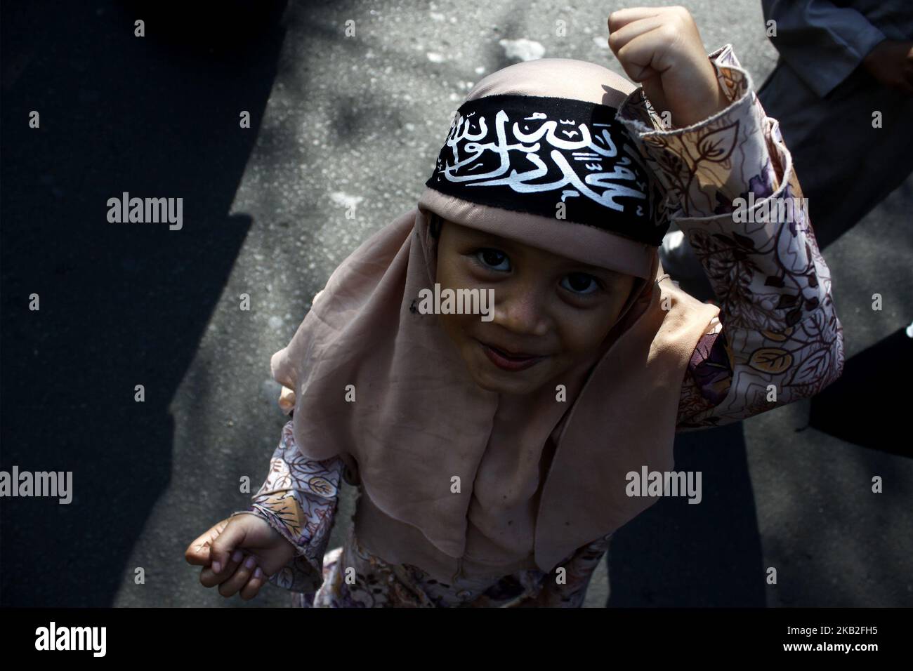 Indonesian Muslims carrying Tawheed flags and other attributes staged ...