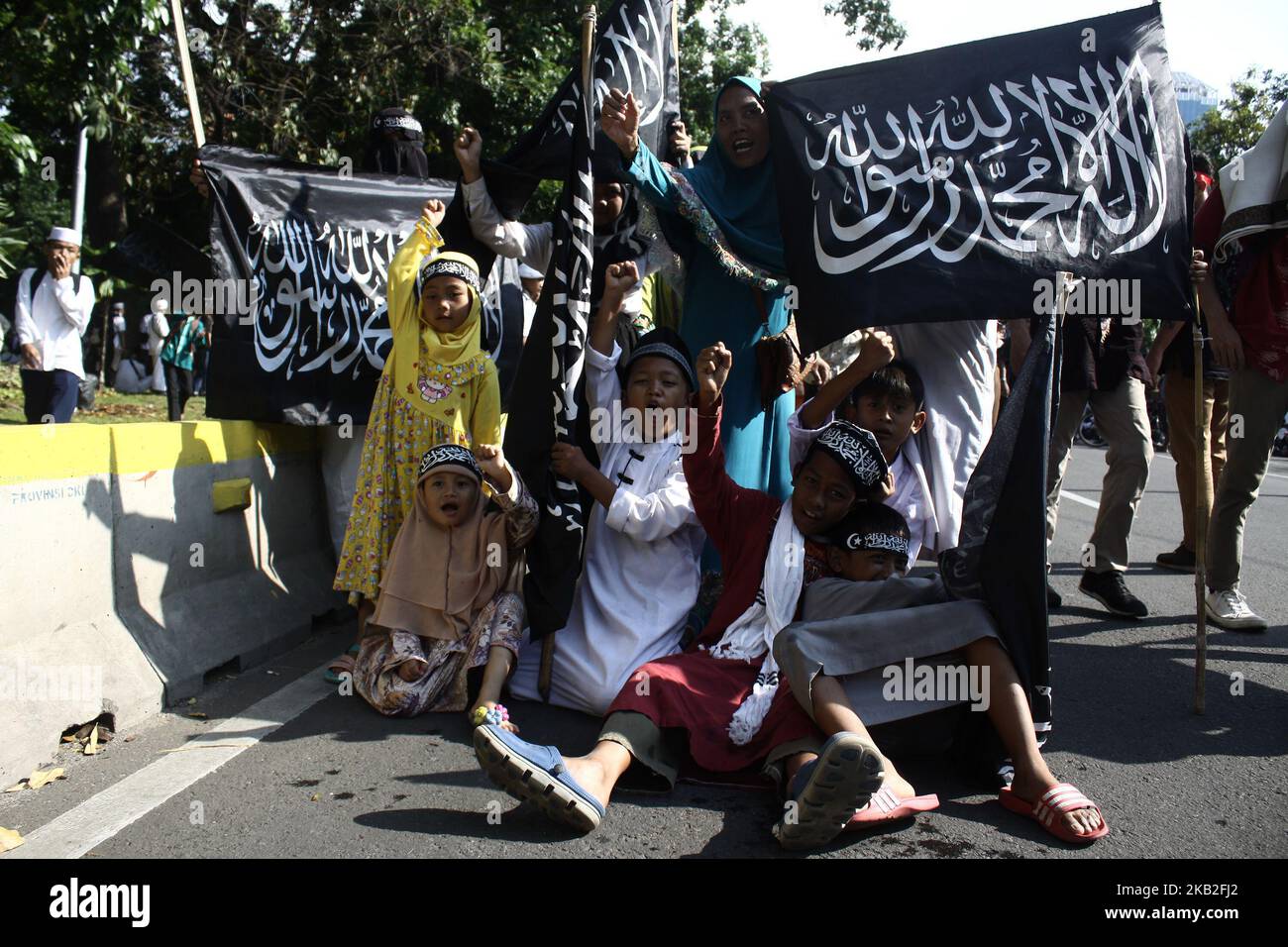 Indonesian Muslims carrying Tawheed flags and other attributes staged ...