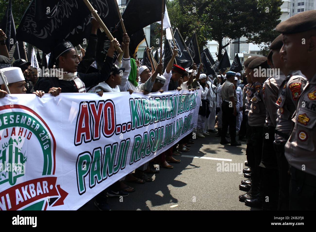 Indonesian Muslims carrying Tawheed flags and other attributes staged ...
