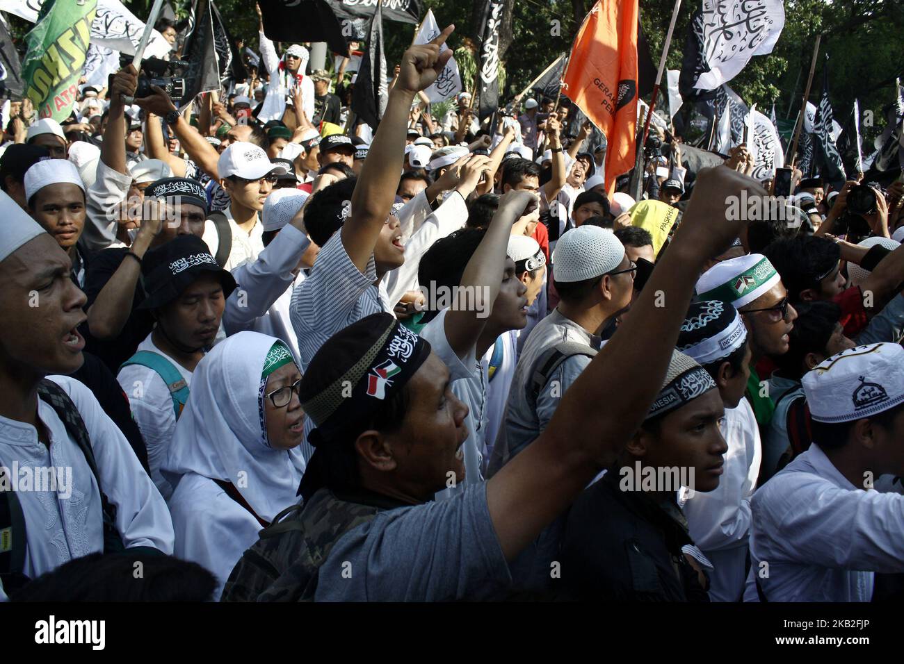 Indonesian Muslims carrying Tawheed flags and other attributes staged ...