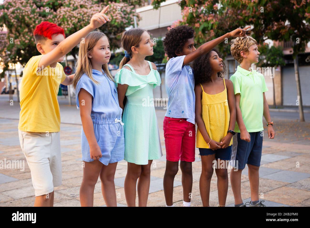 Curious preteen children pointing at something while walking outdoors Stock Photo - Alamy