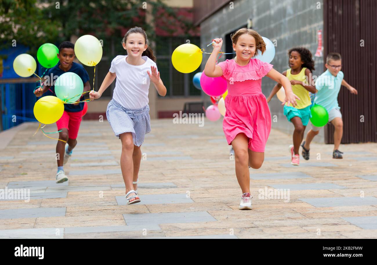 Boy girl colorful balloons running hi-res stock photography and images ...