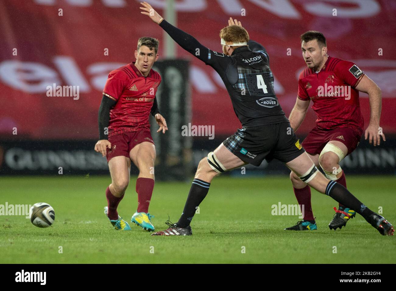 Ian Keatley and Niall Scannell of Munster with Rob Harley of Glasgow ...