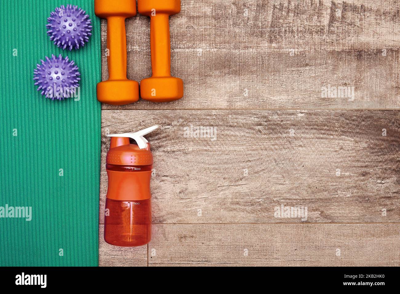 Orange fitness stuff on the gym floor - top view. Sports and activity ...