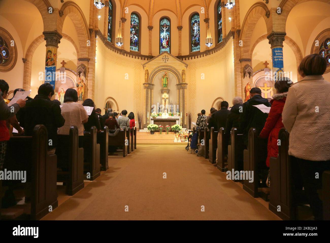 Filipino Catholics sing hymns during a special mass celebrating the ...