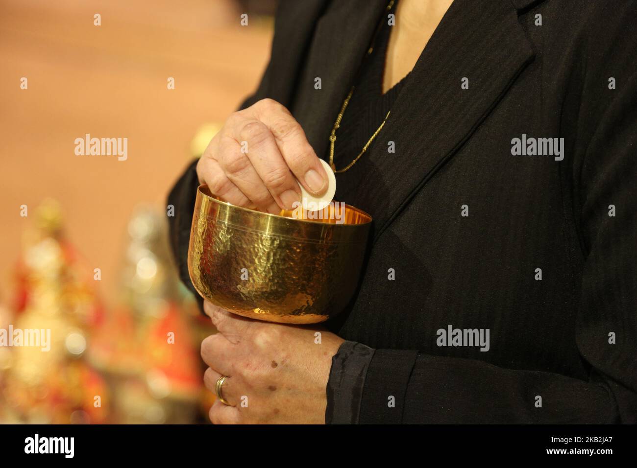 Filipino Catholics take part in communion during a special mass ...