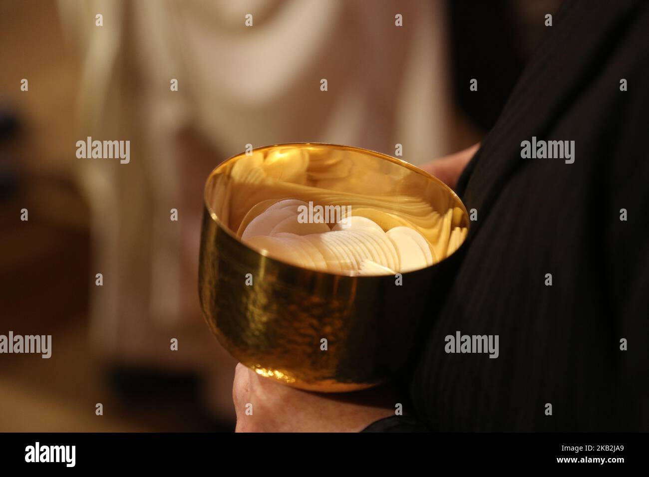 Filipino Catholics take part in communion during a special mass ...