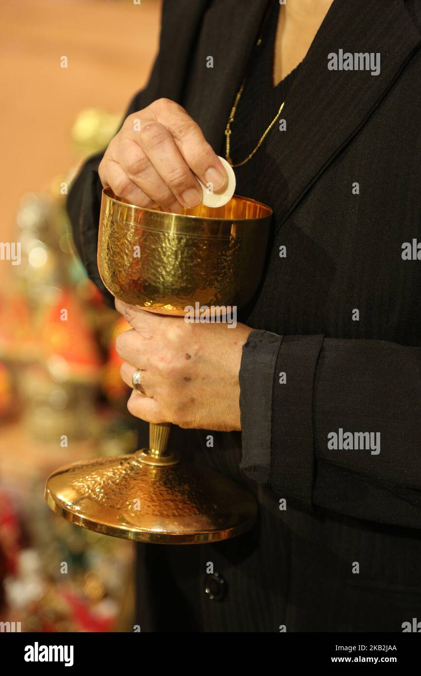 Filipino Catholics take part in communion during a special mass ...