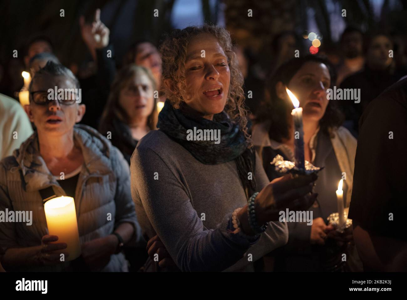 People gather for an interfaith vigil for the victims of the shooting ...