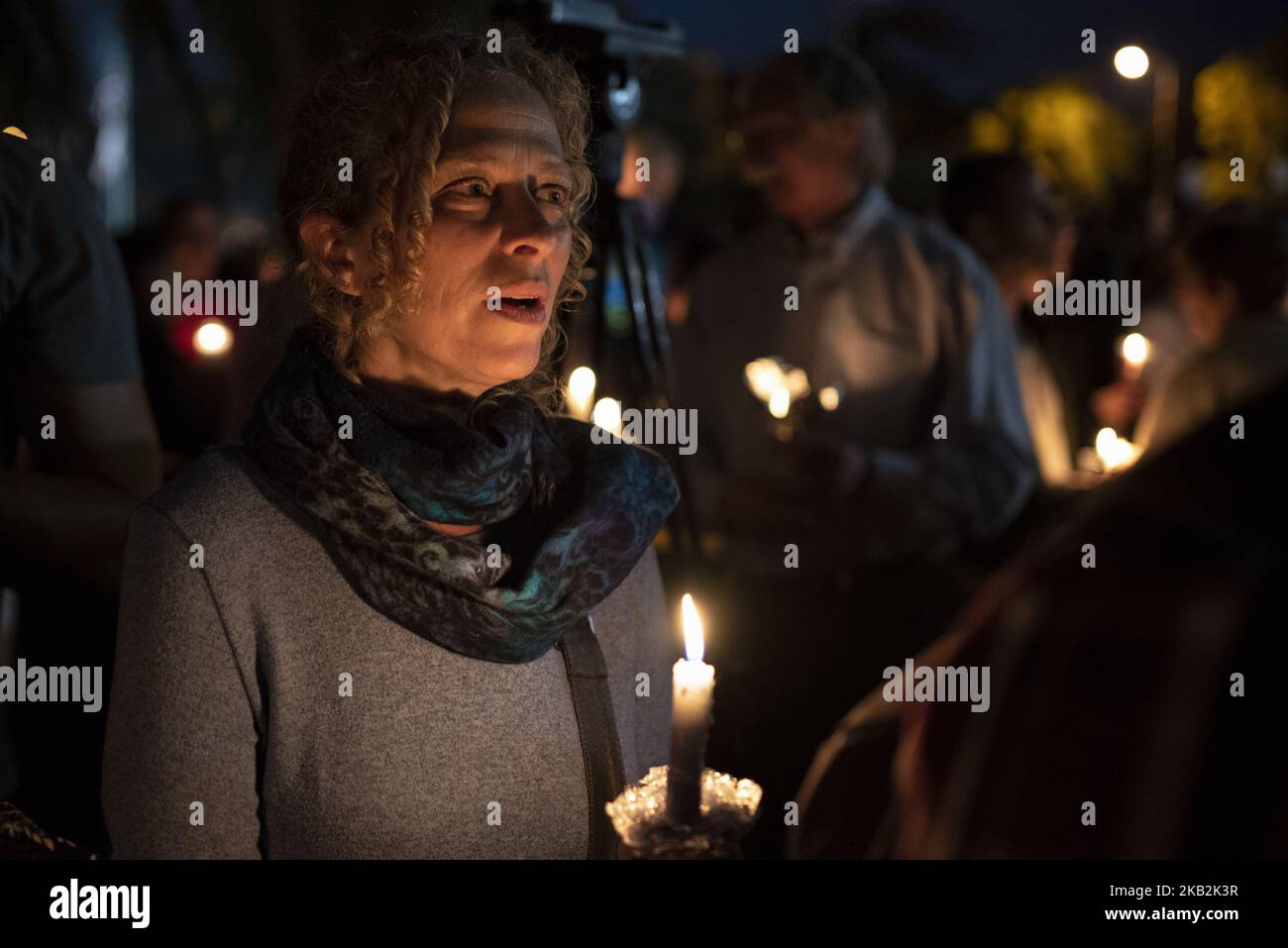 People gather for an interfaith vigil for the victims of the shooting ...