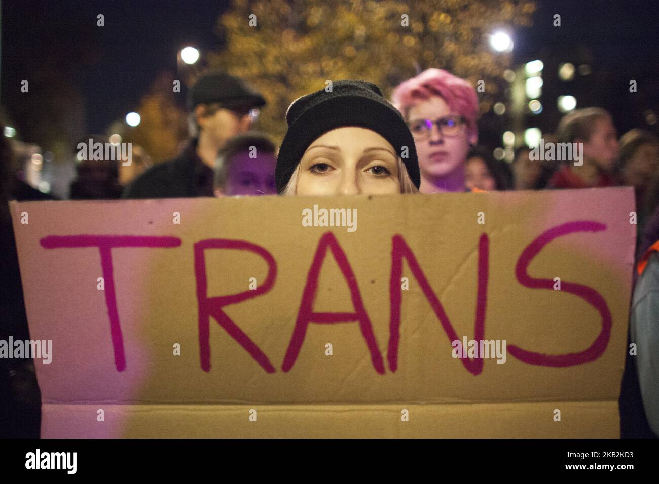 A woman holds Trans banner We wont be erased LGBTQ protest near US ...