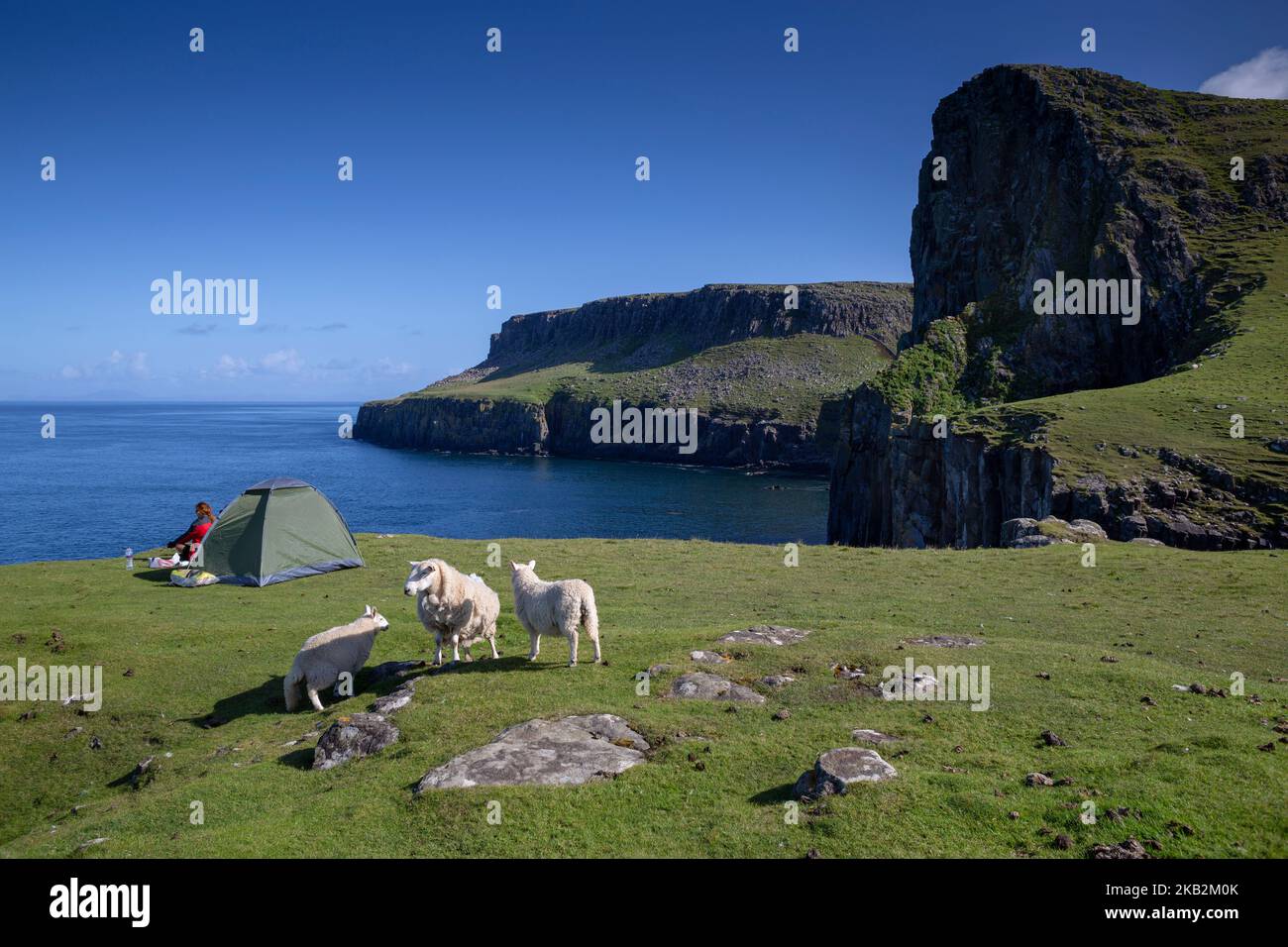 A woman camps at the Neist Cliff lookout at Neist Point Lighthouse on ...