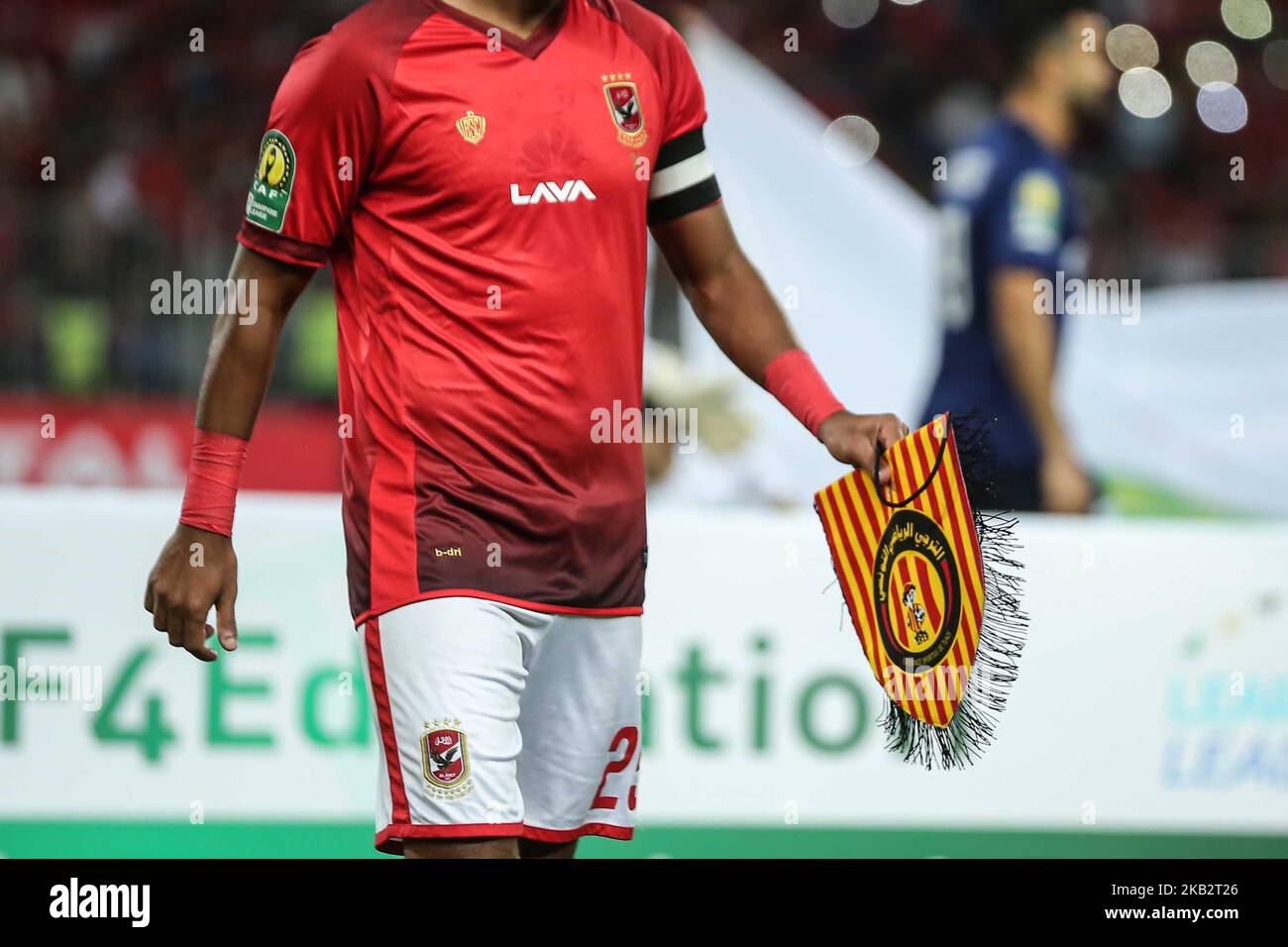 Al-Ahly captain Hossam Ashour holds a pennant as the team Esperance ...