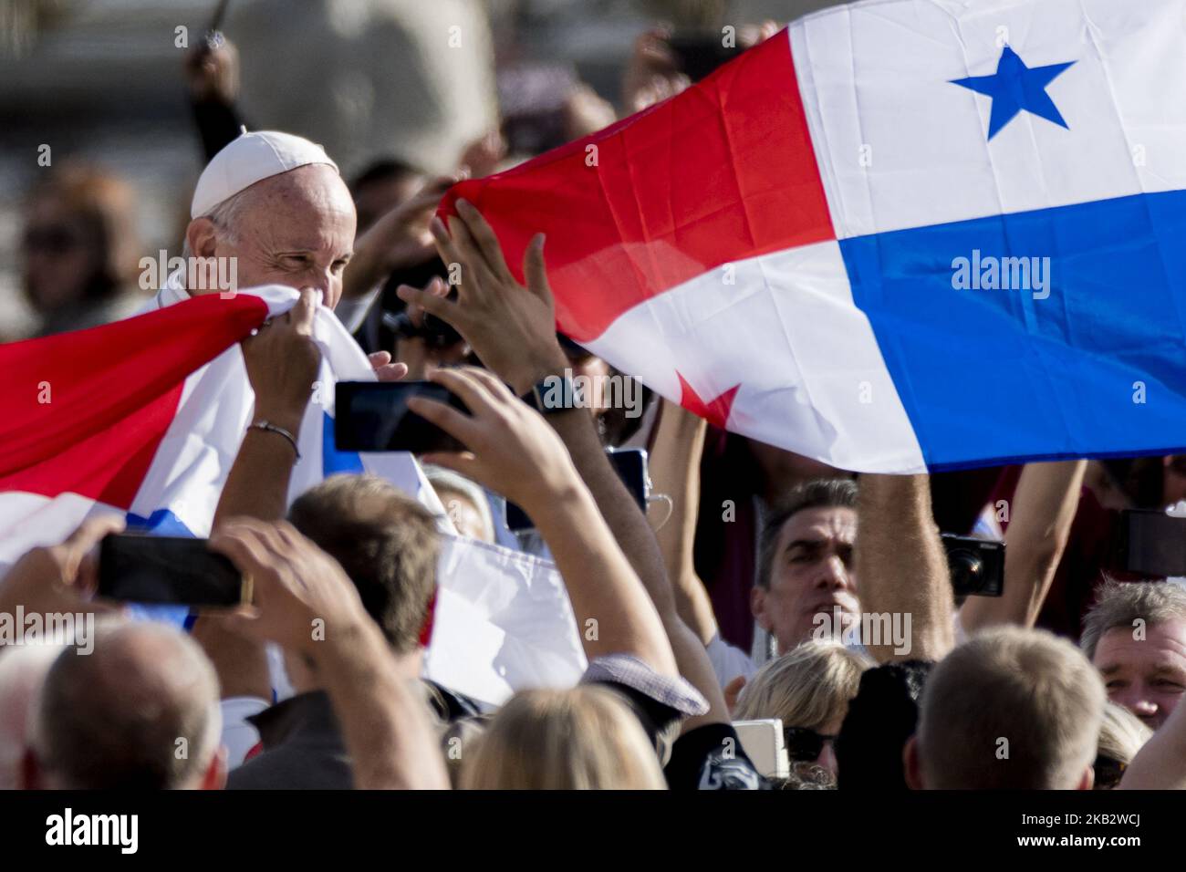 Pope Francis passes next to a group of faithful waving Panama flags as ...