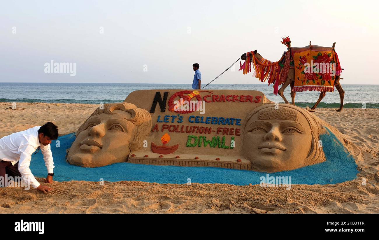 Sand sculpture is seen at the Bay of Bengal Sea's eastern coast beach ...