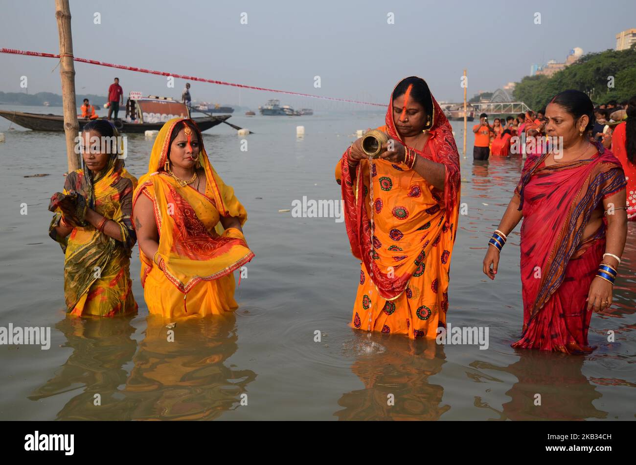 Indian Hindu women devotees offering prayers to the Sun God on the ...