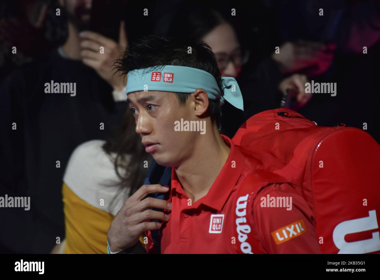 Kei Nishikori of Japan enter the court before his round robin match against Dominic Thiem of ...