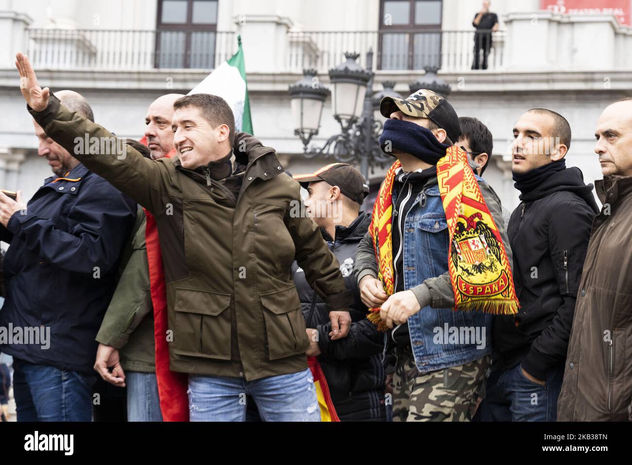 A supporter of Franco makes a fascist salute as he wears a scarf with ...