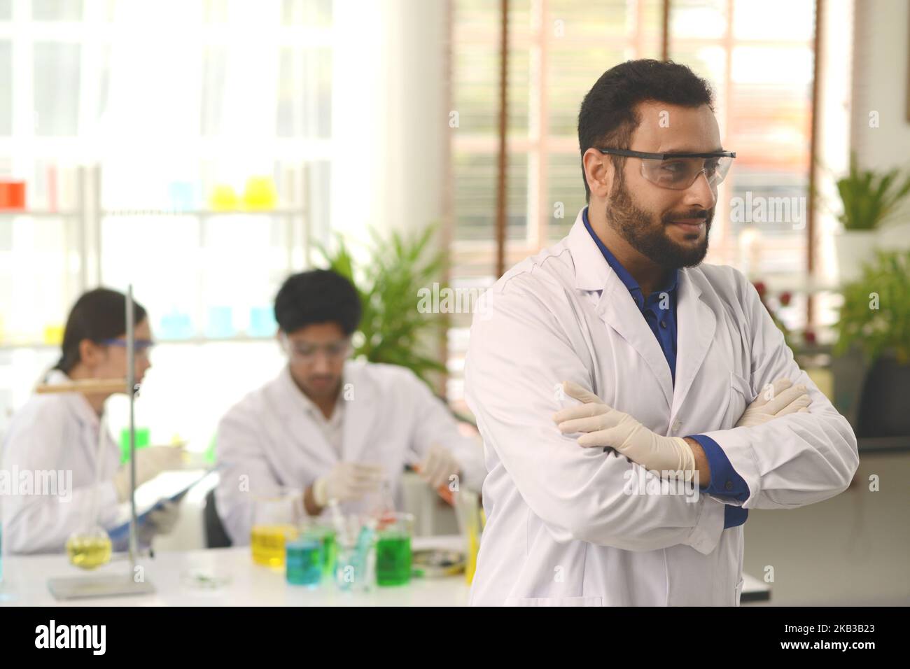 Portrait of a medical scientist in white standing in a modern ...