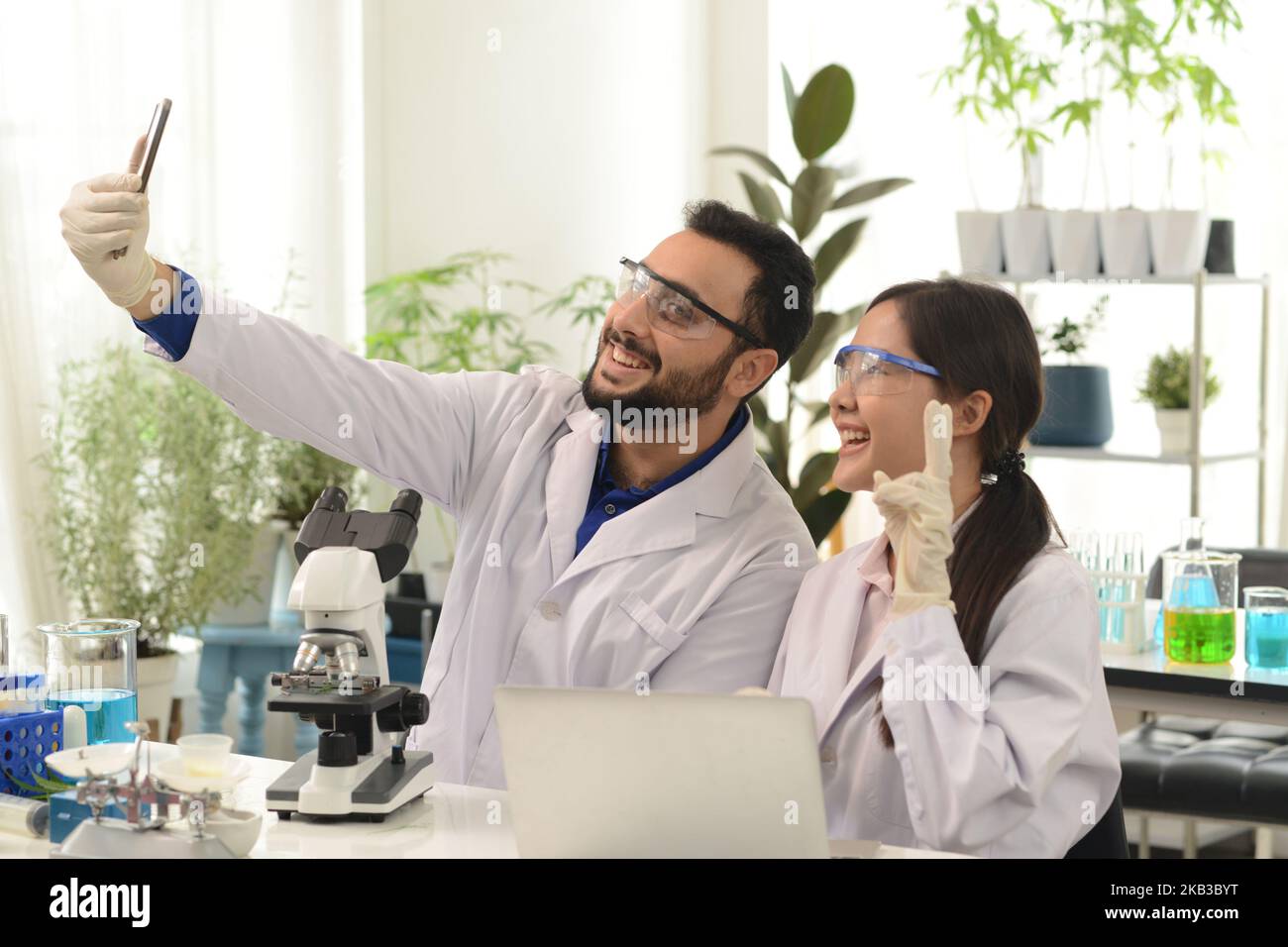 Scientist or chemist taking a selfie with a cell phone With the joy ...