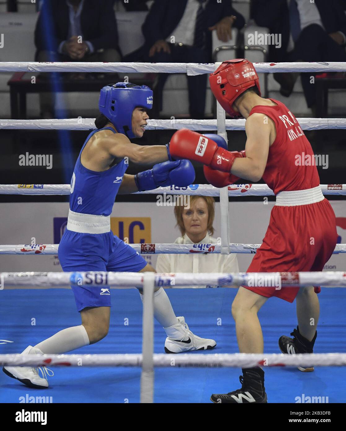 Mary Kom of India (in blue) and Kim Hyang Mi of North Korea (in red ...