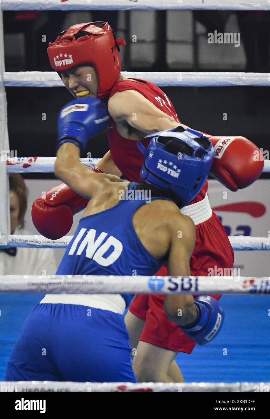 Mary Kom of India (in blue) and Kim Hyang Mi of North Korea (in red ...