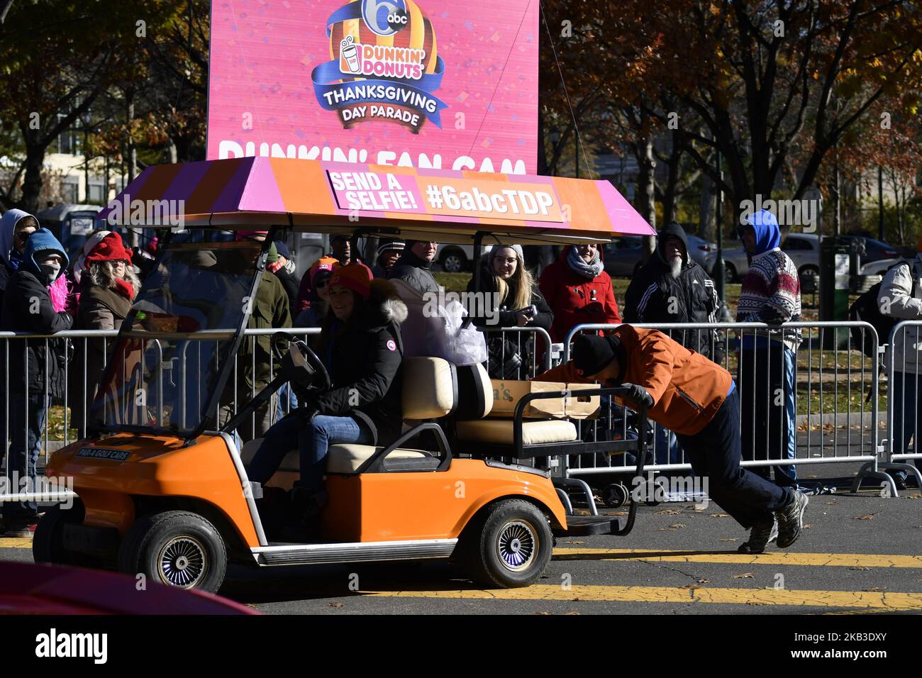 An sponsors' electric golf cart with an empty battery is pushed during ...