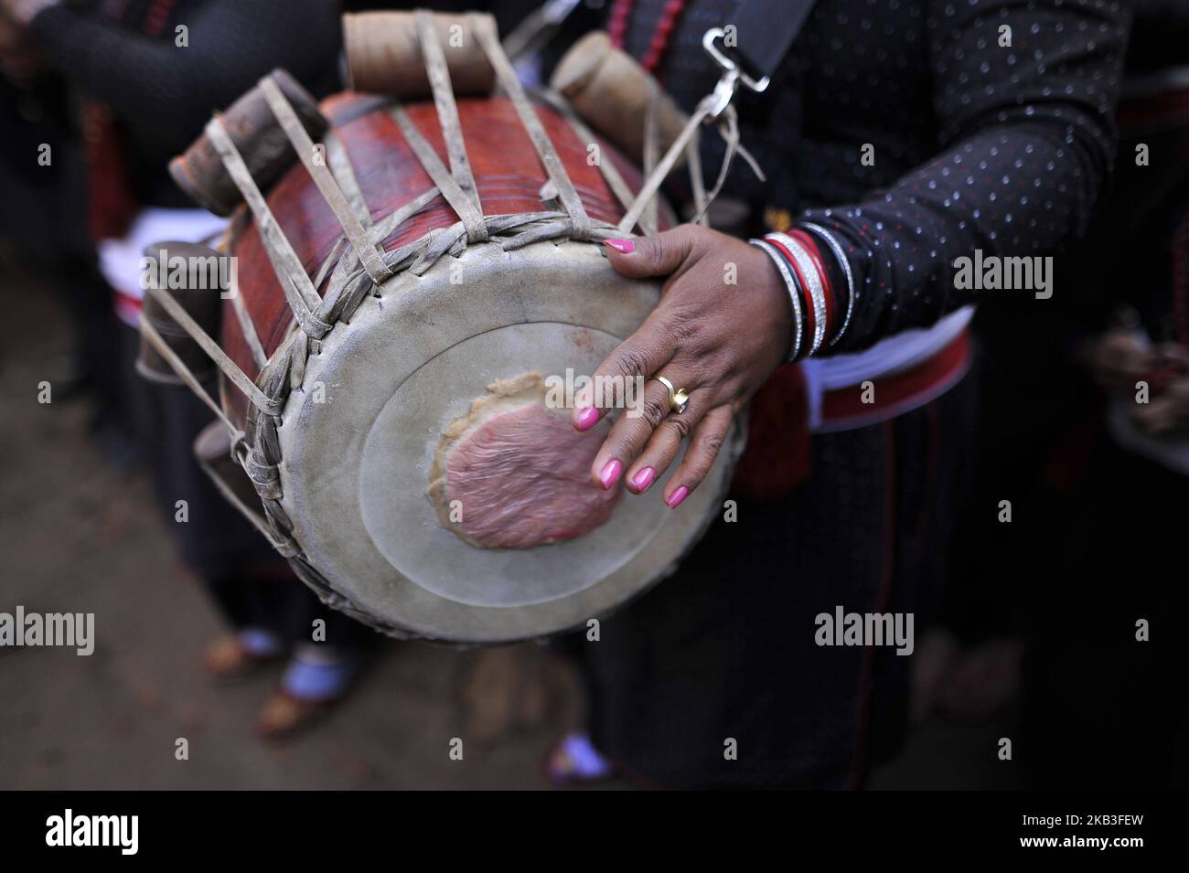 A Nepalese girl playing traditional instrument during the celebration ...
