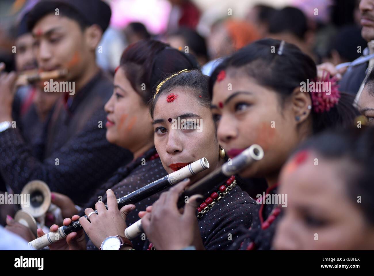 Nepalese girls playing traditional flute during the celebration of ...