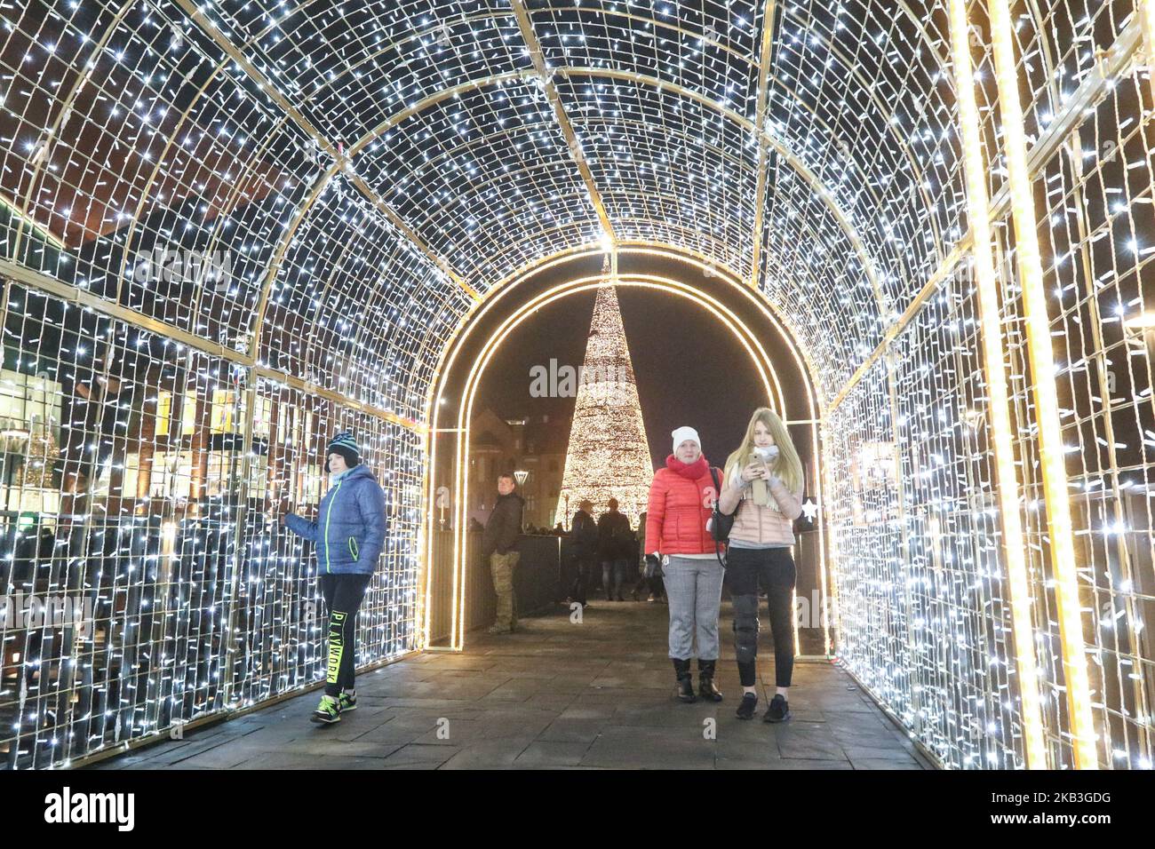 Crowd admiring Christmas tree lights is seen in Gdansk, Poland on 24 ...