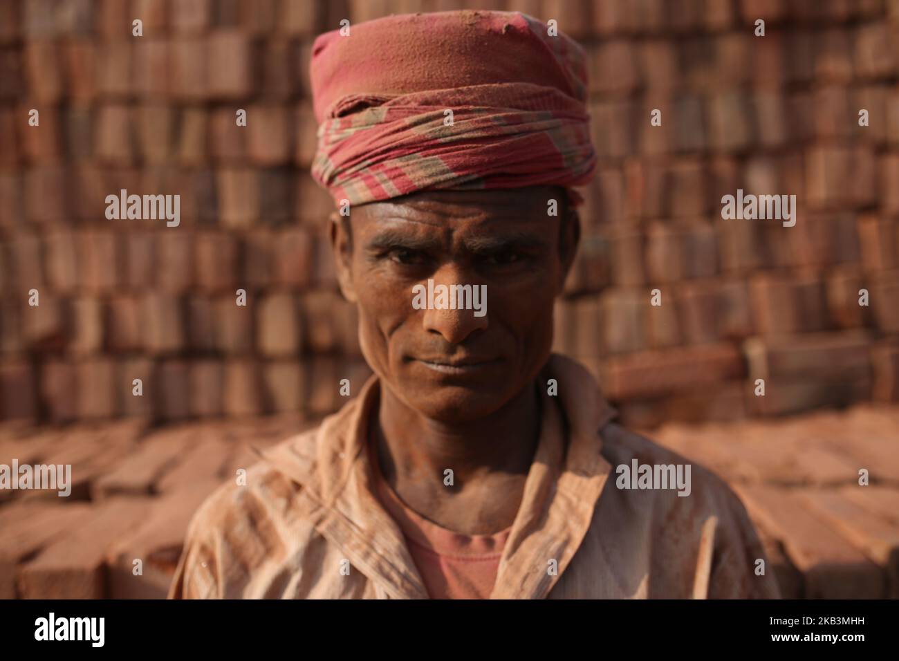 A Bangladeshi labor poses for a photograph at a brick field in Dhaka ...