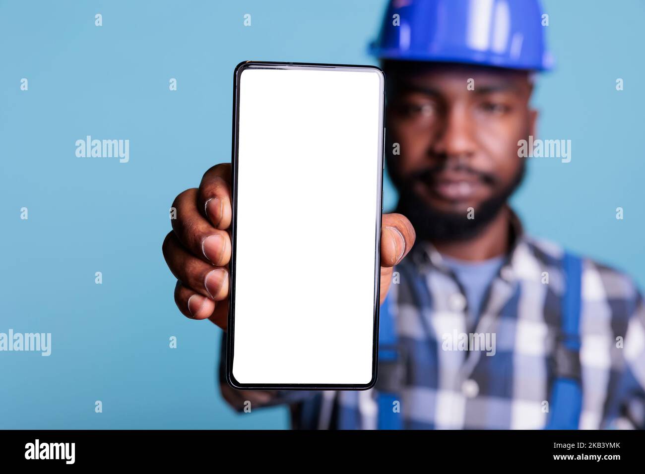 Confident african american contractor holding cell phone with white ...