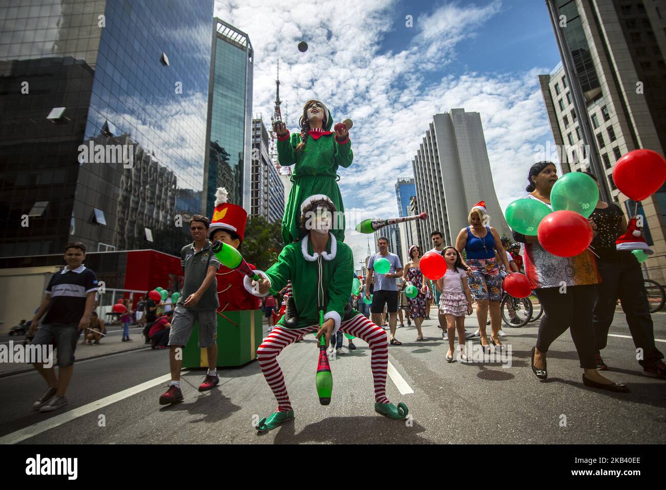 People take part in a Christmas flash mob through streets in Sao Paulo ...