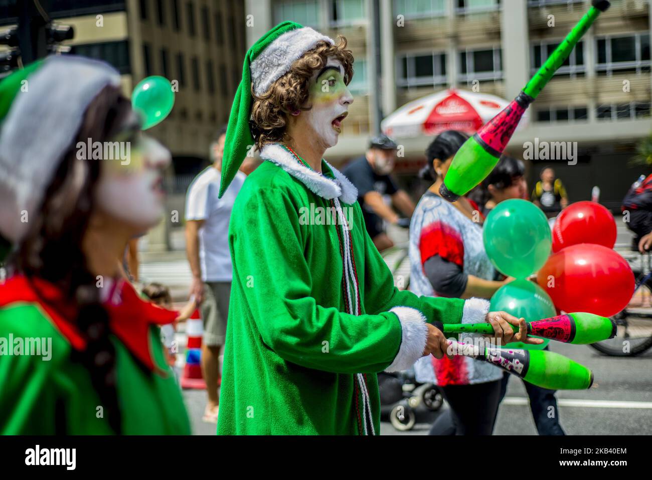 People take part in a Christmas flash mob through streets in Sao Paulo ...