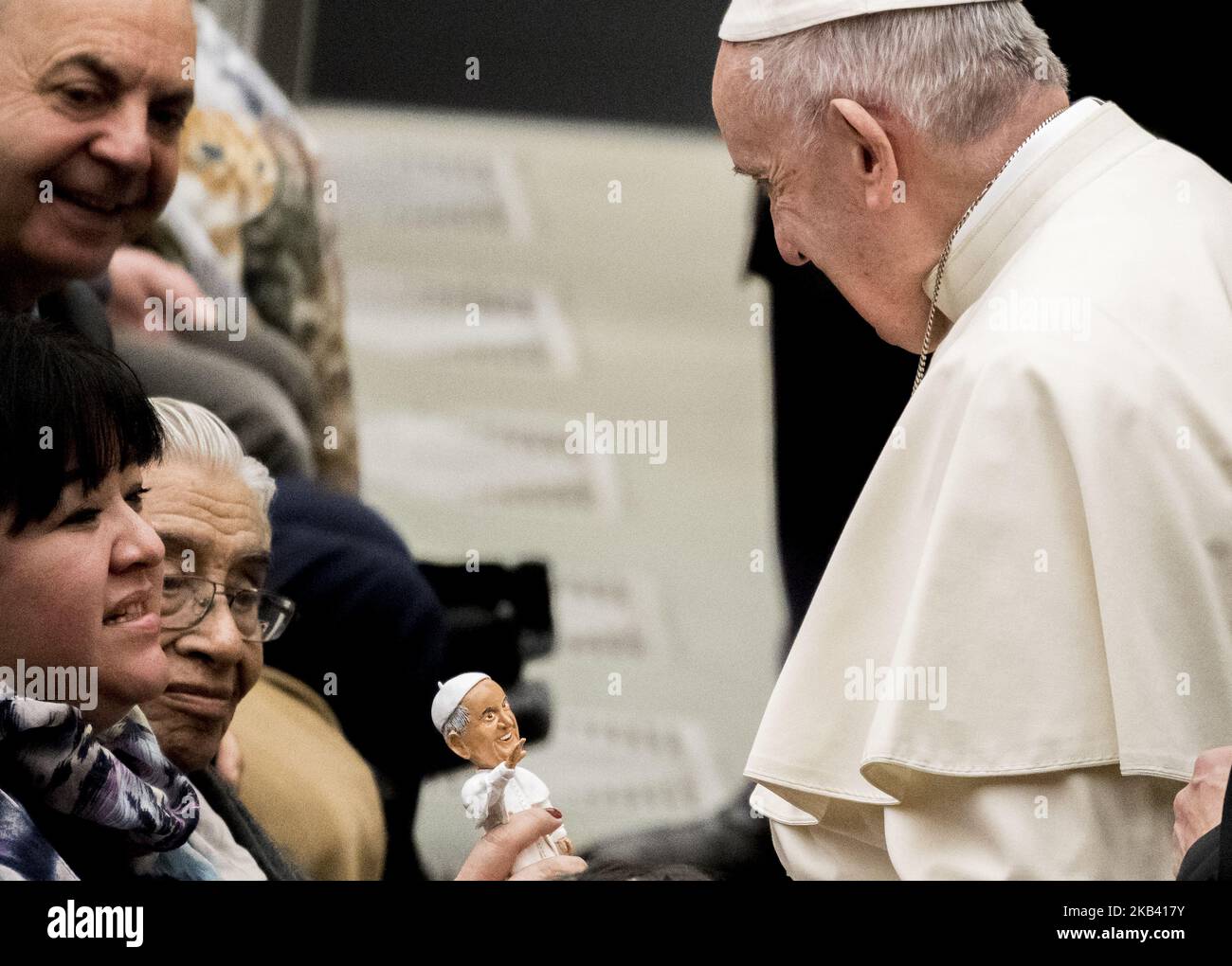 A faithful put a present to Pope Francis a statuette depicting the Pope ...