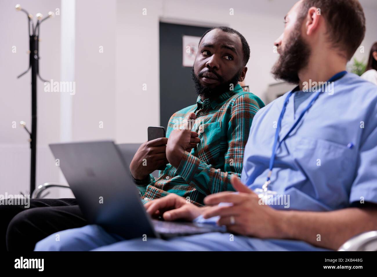 African american concerned patient talking to nurse. Hospital medical ...