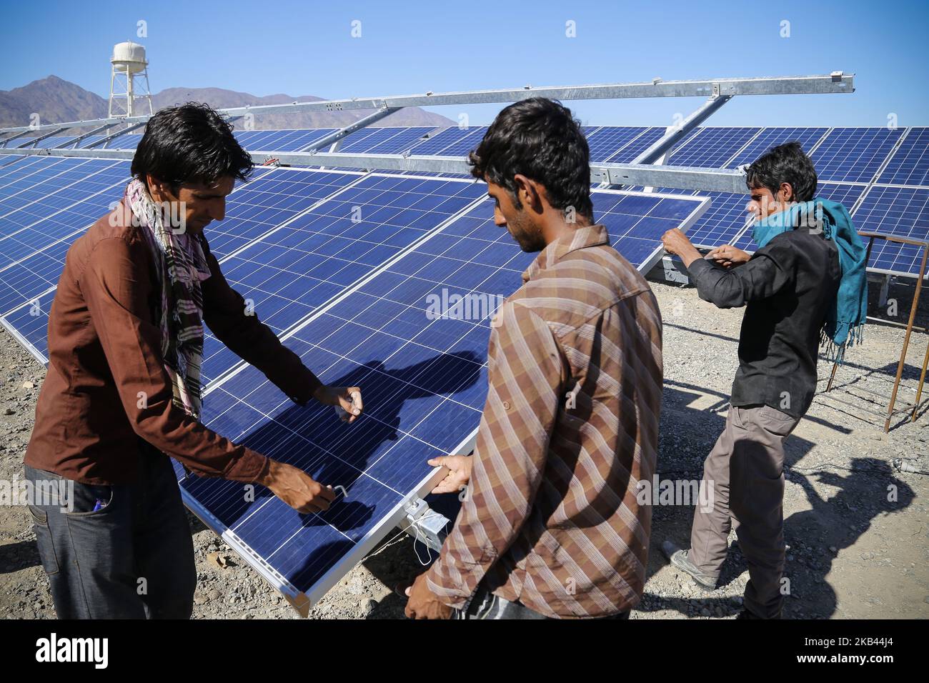 Iranian workers work in a solar power farm in Qaleh Ganj County, Kerman Province, Iran, on ...