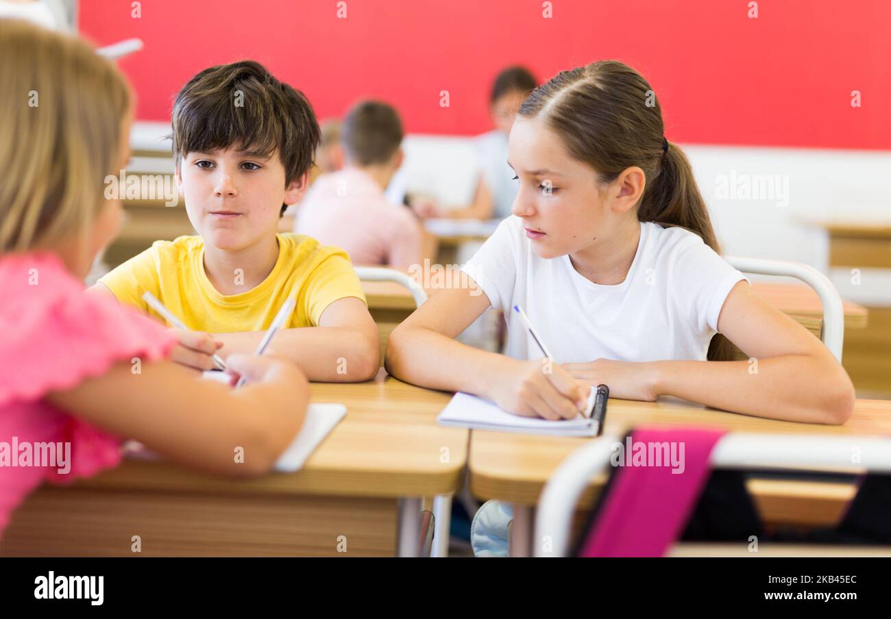 Tweens working in small groups during lesson at school Stock Photo - Alamy