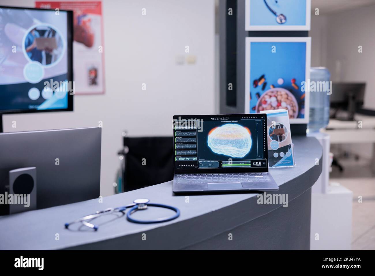 Brain scan displayed on laptop screen on doctor office desk ...