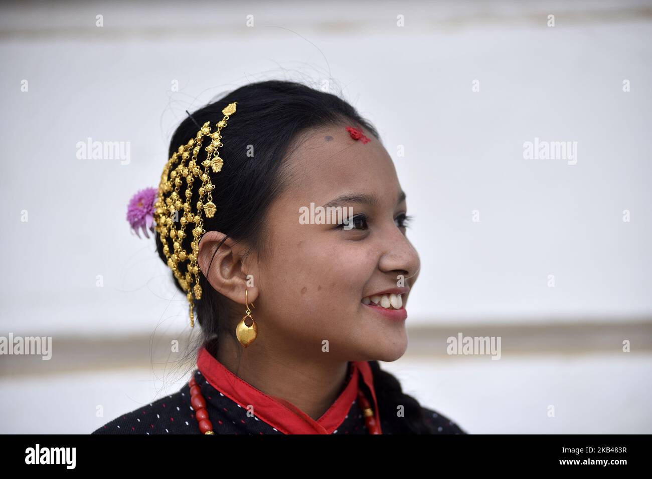A Newari girl in a traditional attire pose for the photo during a ...