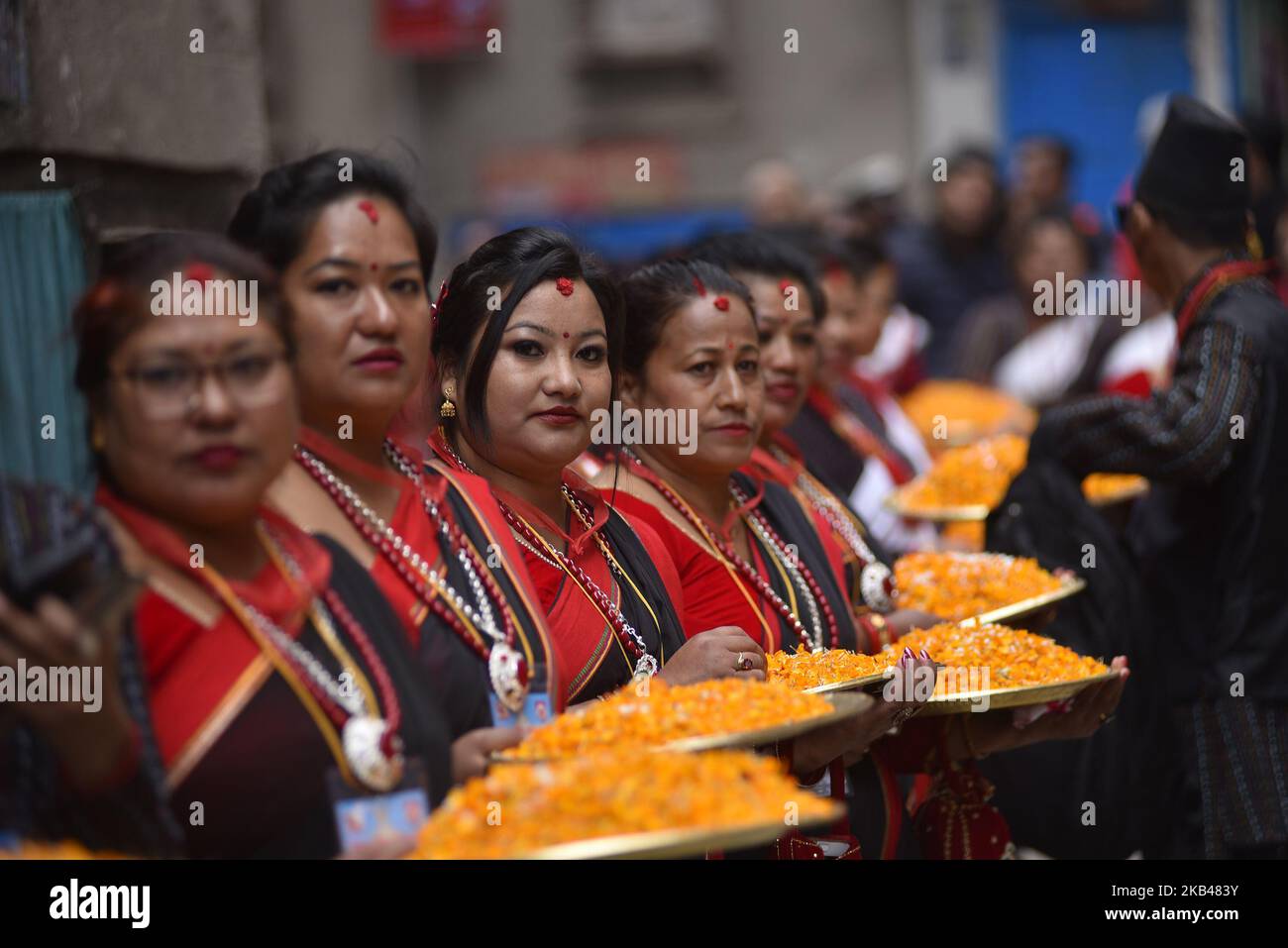 People from Newar community carrys flower to welcome people in a parade ...