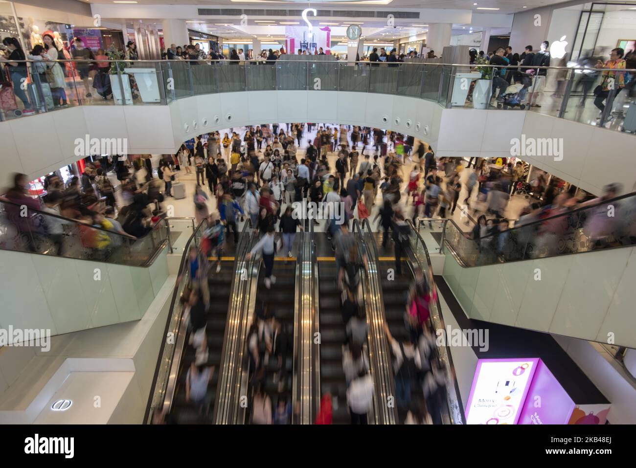 A Long exposure photo showing crowded escalators inside a Shopping Mall ...