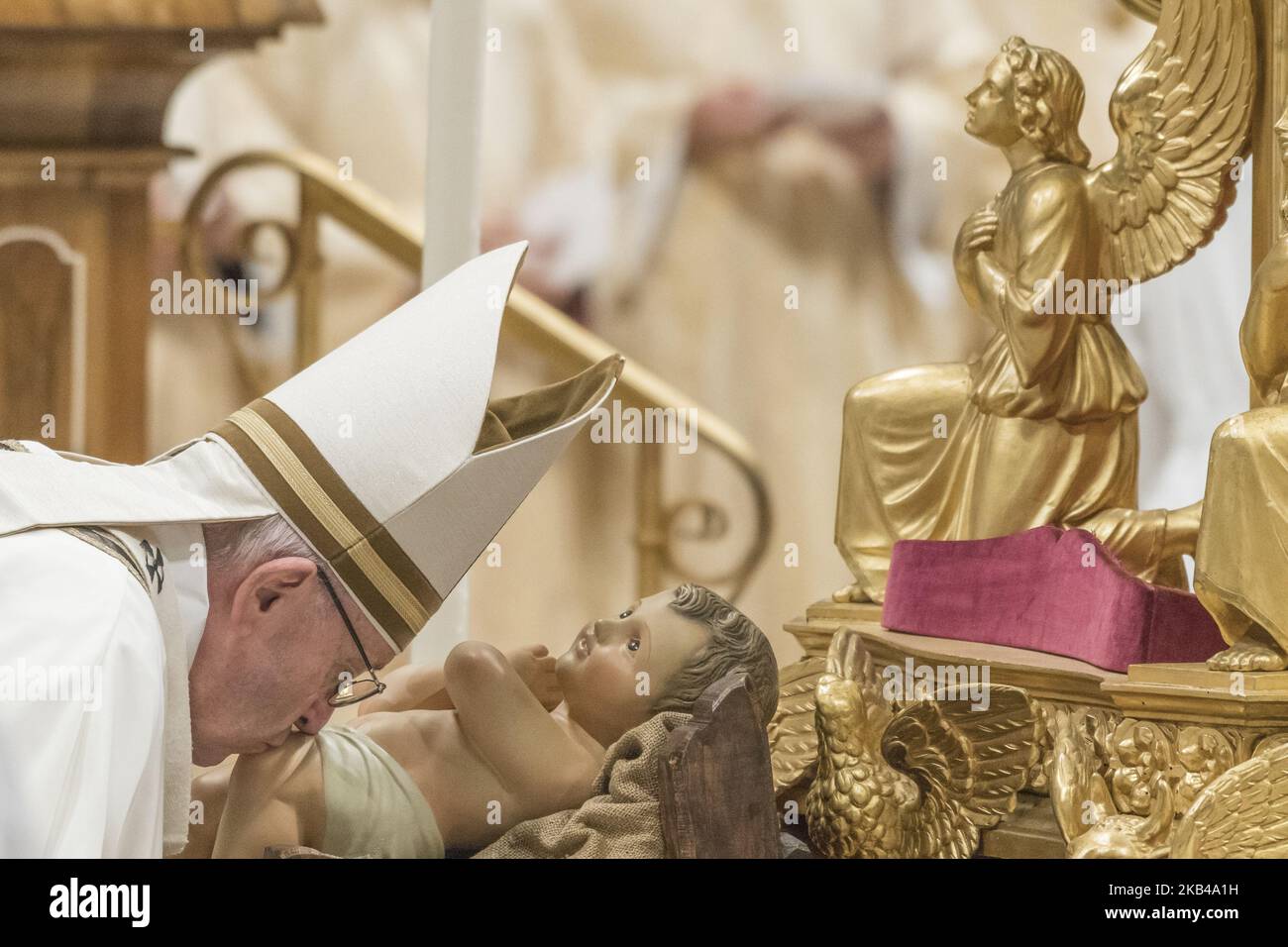 Pope Francis kisses a statue of Baby Jesus as he celebrates the ...