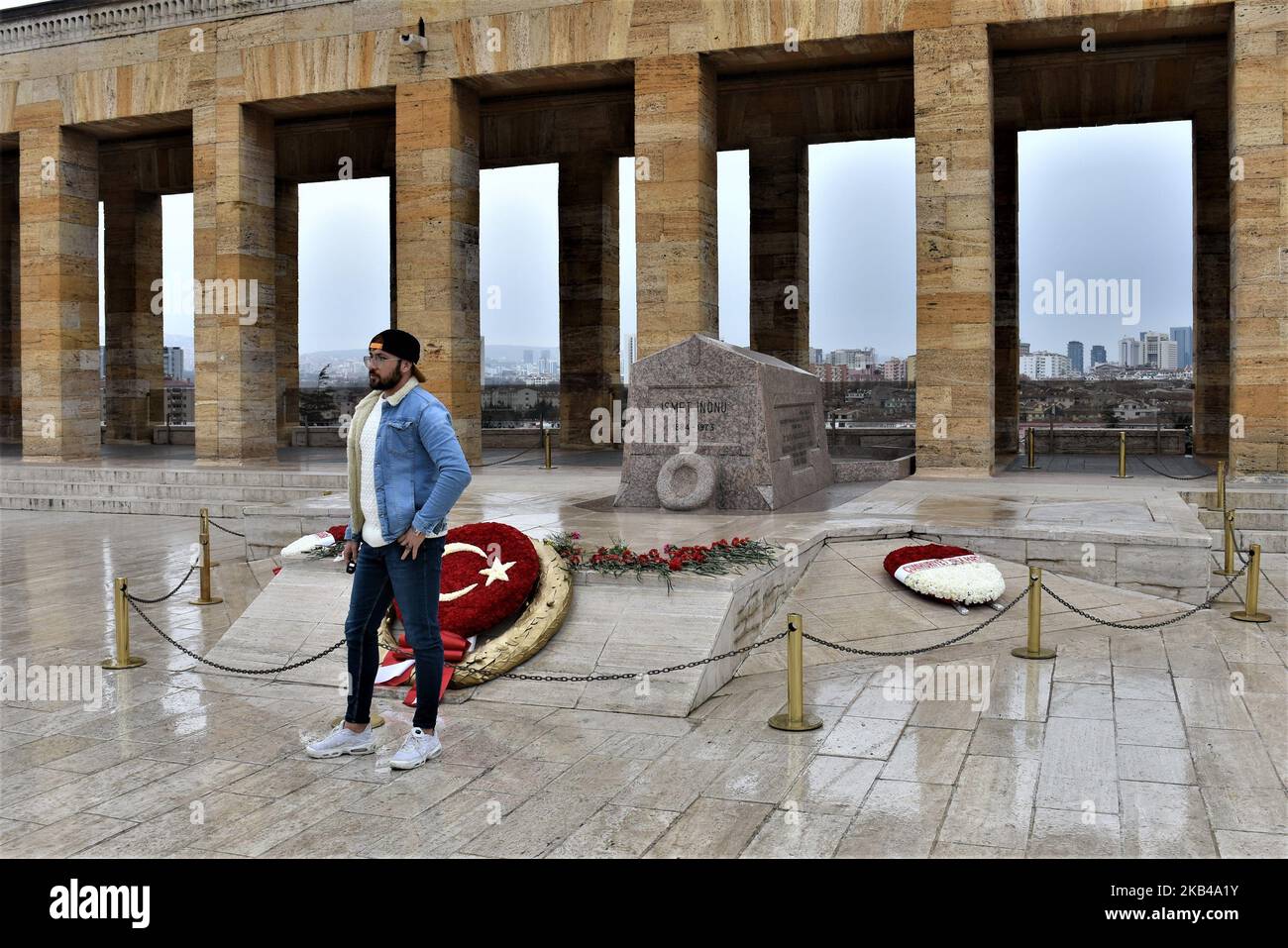 A visitor poses for a photograph in front of the tomb of Ismet Inonu ...