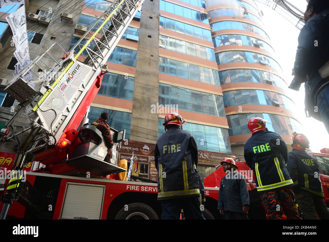 Bangladeshi firefighters work to douse a fire at the Zaman Tower that ...