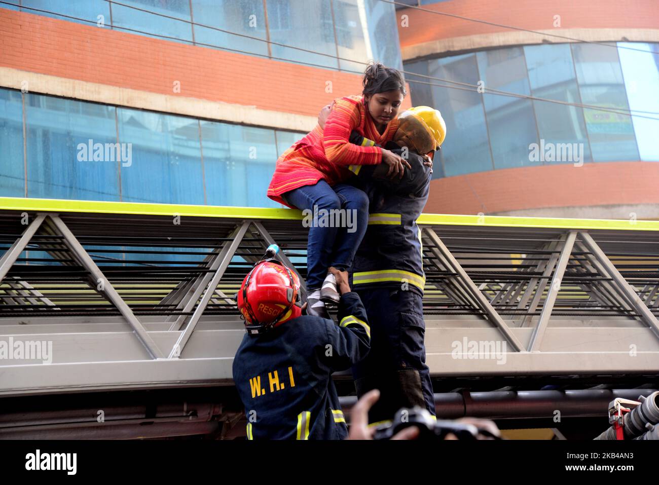 A firefighter rescuing a victim of a fire with arms around at capitals ...