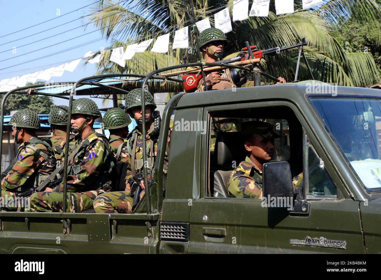 Bangladeshi army personnel drive a military vehicle through a street ...