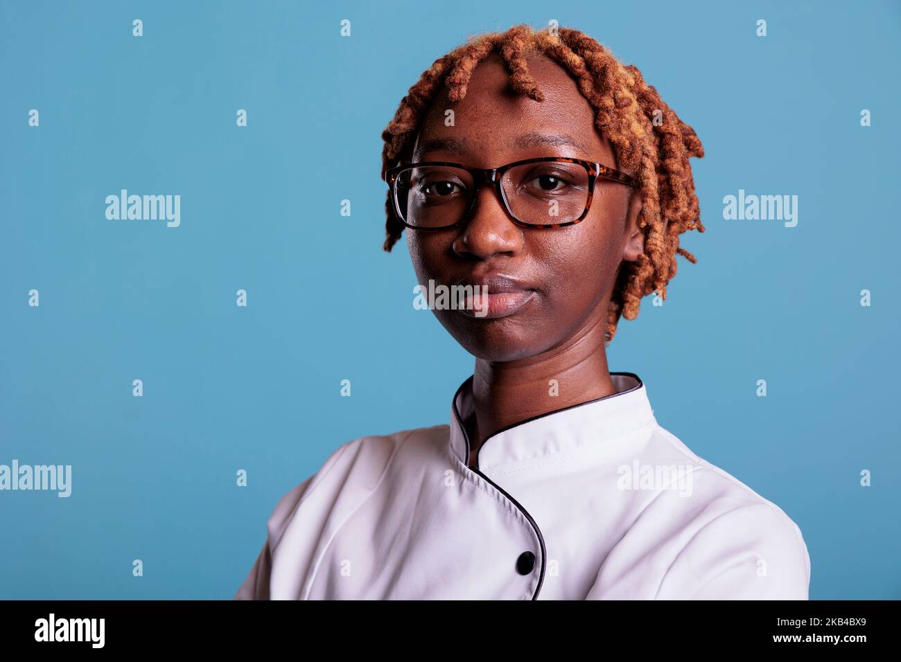 African american female chef wearing uniform, glasses close up portrait ...